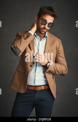 Young man posing with a trendy outfit against a urban background Stock ...