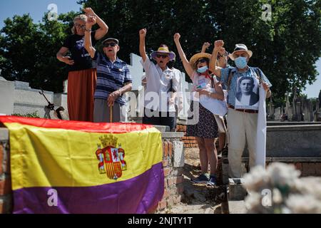 Relatives and family members with their fist raised at the tomb of the ...