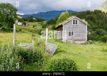 Elderly wooden buildings on a hillside. Outdoor museum in the sunshine ...