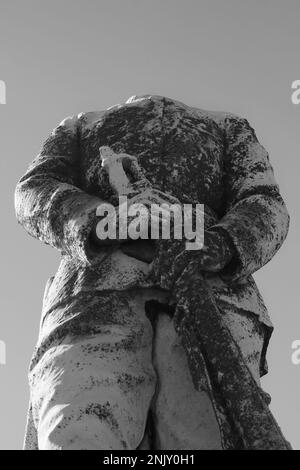 A headless vintage military soldier standing with his sword in hIs hand ...