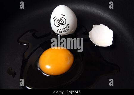 egg in the pan, painted with a bad-tempered face Stock Photo - Alamy