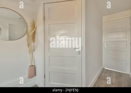 Entrance hall of a house with an L-shaped corridor with door carpentry ...