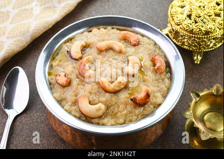Plate with traditional Indian food pongal on wooden table Stock Photo ...