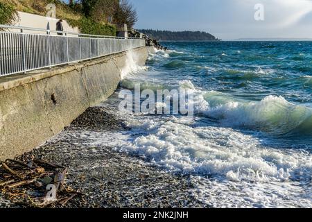 Wind blows waves into the sea wall in West Seattle, Washingon Stock ...