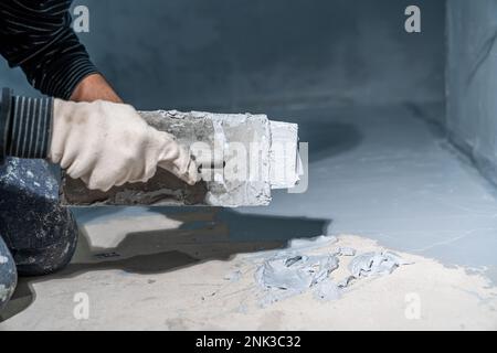 construction modifications of the floor and walls with trowel of a room ...