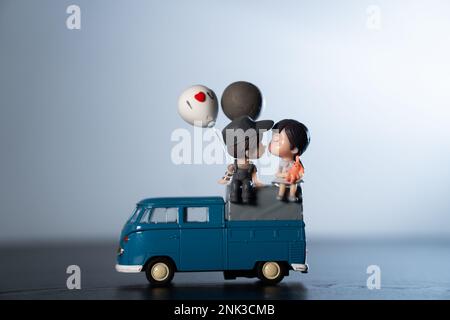 cute lovers toys with balloon going for a holiday Stock Photo - Alamy