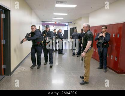 Tulsa Police Lt. Will Toliver helps Tulsa Police Academy cadets Darien ...