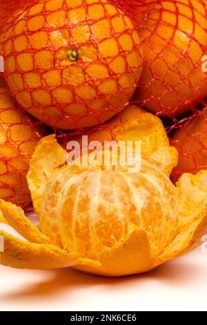 Ripe Mandarin fruit peeled open Stock Photo - Alamy
