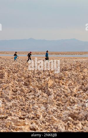 Walking across of Salt formations in Atacama Salt Flat, Atacama Desert ...