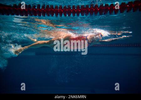 Coordinated movements, speed. Professional female swimmer training in ...