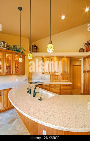 Views of a semi-circular countertop and wood cabinets in this ...