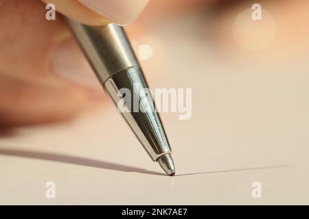 The macro roller of the ballpoint pen draws a line on paper Stock Photo ...