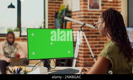 Businesswoman working remotely with greenscreen on computer, using ...