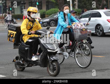 A staff of Meituan rides a bike in Beijing, China on April 12, 2022 ...