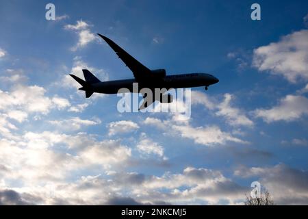 Commercial aircraft overflying the sky and arriving at airport Stock ...