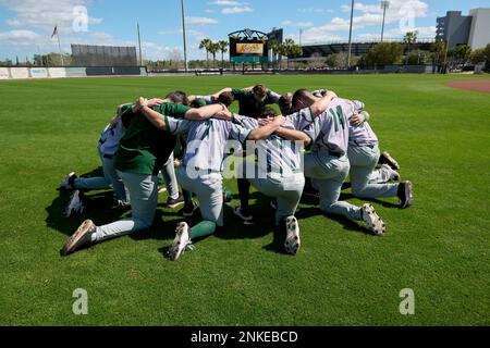 Siena Saints team huddle before an NCAA baseball game against the UCF ...