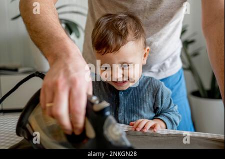 Father ironing clothes at home Stock Photo - Alamy