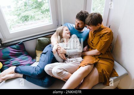 Mother with child talking with two men Stock Photo - Alamy