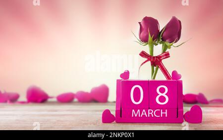 Calendar with date of International Women's Day and flowers on yellow ...