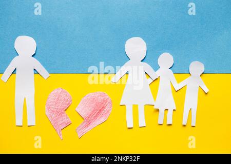 paper cut divided family on the background of the ukrainian flag. stop ...