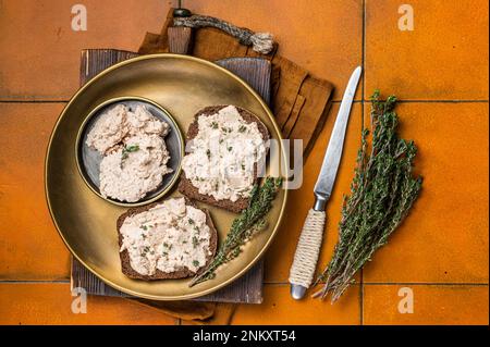 Toasts with Cod liver Spread pate on a plate. Isolated on white ...