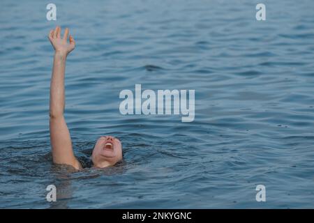 Drowning woman reaching for help in sea Stock Photo - Alamy