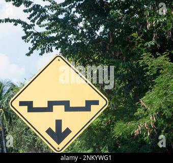 yellow traffic sign indicating speed reducer on the track - bump ...