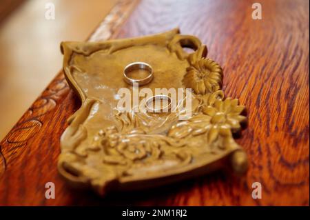 Wedding rings on golden platter in church Stock Photo - Alamy