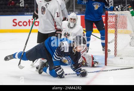 Finland's Ville Koivunen (24) scores a goal on Austria's goalie ...