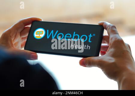 In this photo illustration the Woebot Health logo seen displayed on a ...