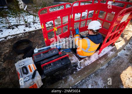 Female BT Openreach worker installing broadband fibre cables Stock ...