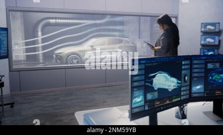 Engineers check aerodynamics of eco-friendly electric car in lab for ...