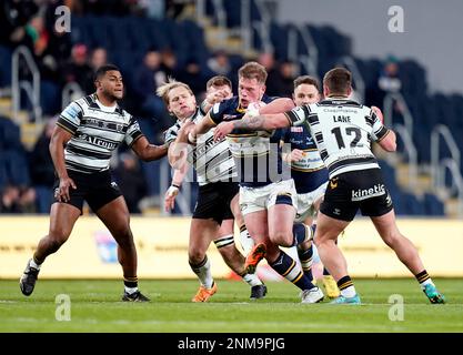 Tom Holroyd of Leeds Rhinos is tackled by Benjamin Garcia of Catalan ...
