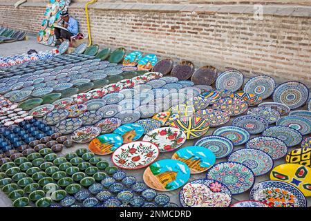 Craftsman selling traditional uzbek pottery, Bukhara, Uzbekistan Stock ...