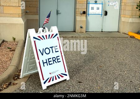Sign designating the voting polling place location - vote here. St Paul ...