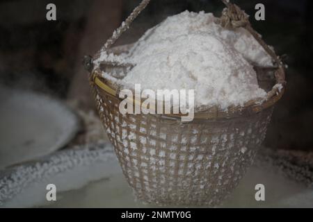 boiling saline solution in pan is traditional way for making mountain ...