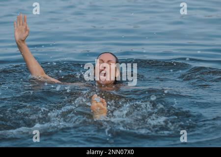 Drowning woman reaching for help in sea Stock Photo - Alamy