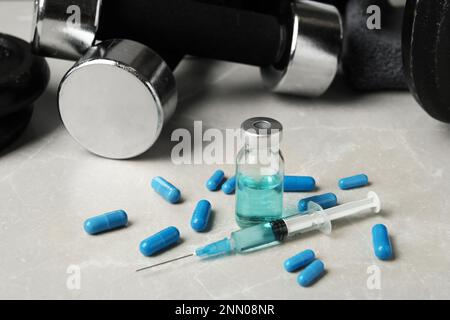 Different drugs and sports equipment on grey background, flat lay ...