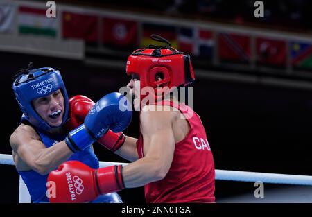 Italy's Irma Testa, in blue, exchange punches with Canada's Caroline ...