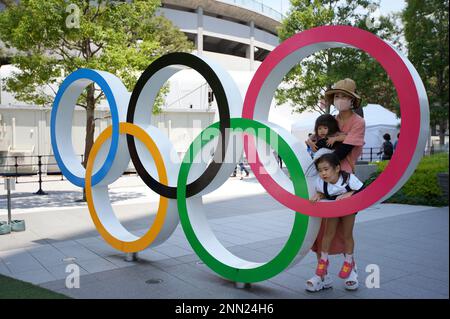 People pose with the Olympic Five-Ring Emblem at Japan Sport Olympic ...