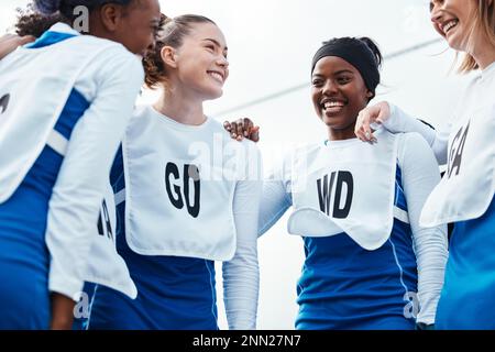 Women, netball and team talking, happy and smile after training, game ...