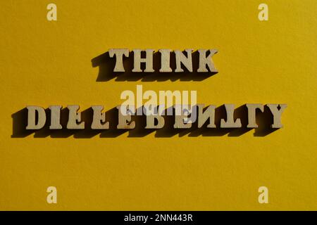 We Think Differently Here, words in wooden alphabet letters isolated on ...