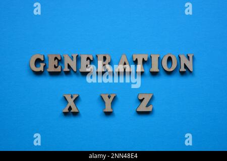 Gen Y, words in wooden alphabet letters isolated on pink, purple and ...