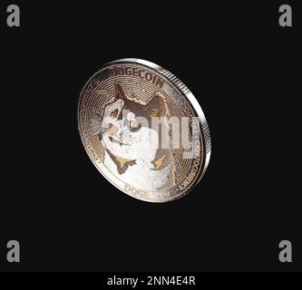A dimly lit physical doge cryptocurrency in bronze and silver coin form ...