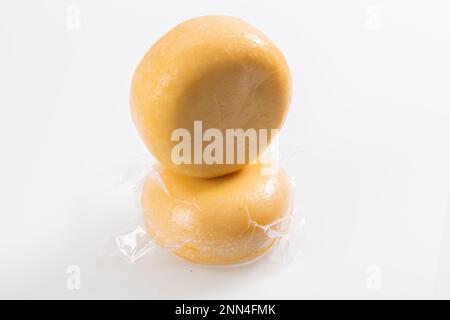 A piece of homemade vacuumed traditional Bosnian cheese isolated on a ...