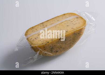 A piece of homemade vacuumed traditional Bosnian cheese isolated on a ...
