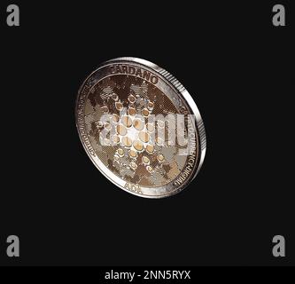 A dimly lit physical cardano cryptocurrency in bronze and silver coin ...