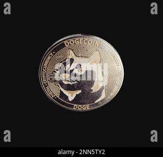 A dimly lit physical doge cryptocurrency in bronze and silver coin form ...