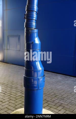 A large bore pipe channelling waste water down into a surface drain ...