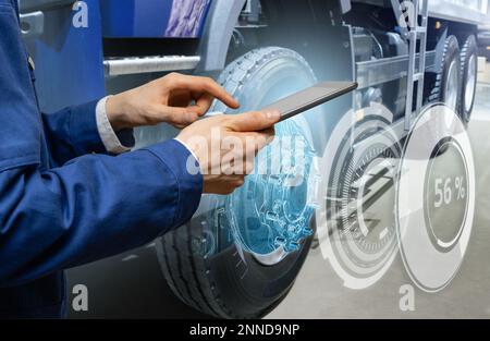Serviceman repairing a truck using augmented reality application Stock ...